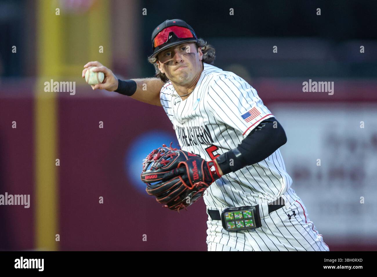 Northeastern infielder Jack Goodman (5) warms up before an NCAA ...