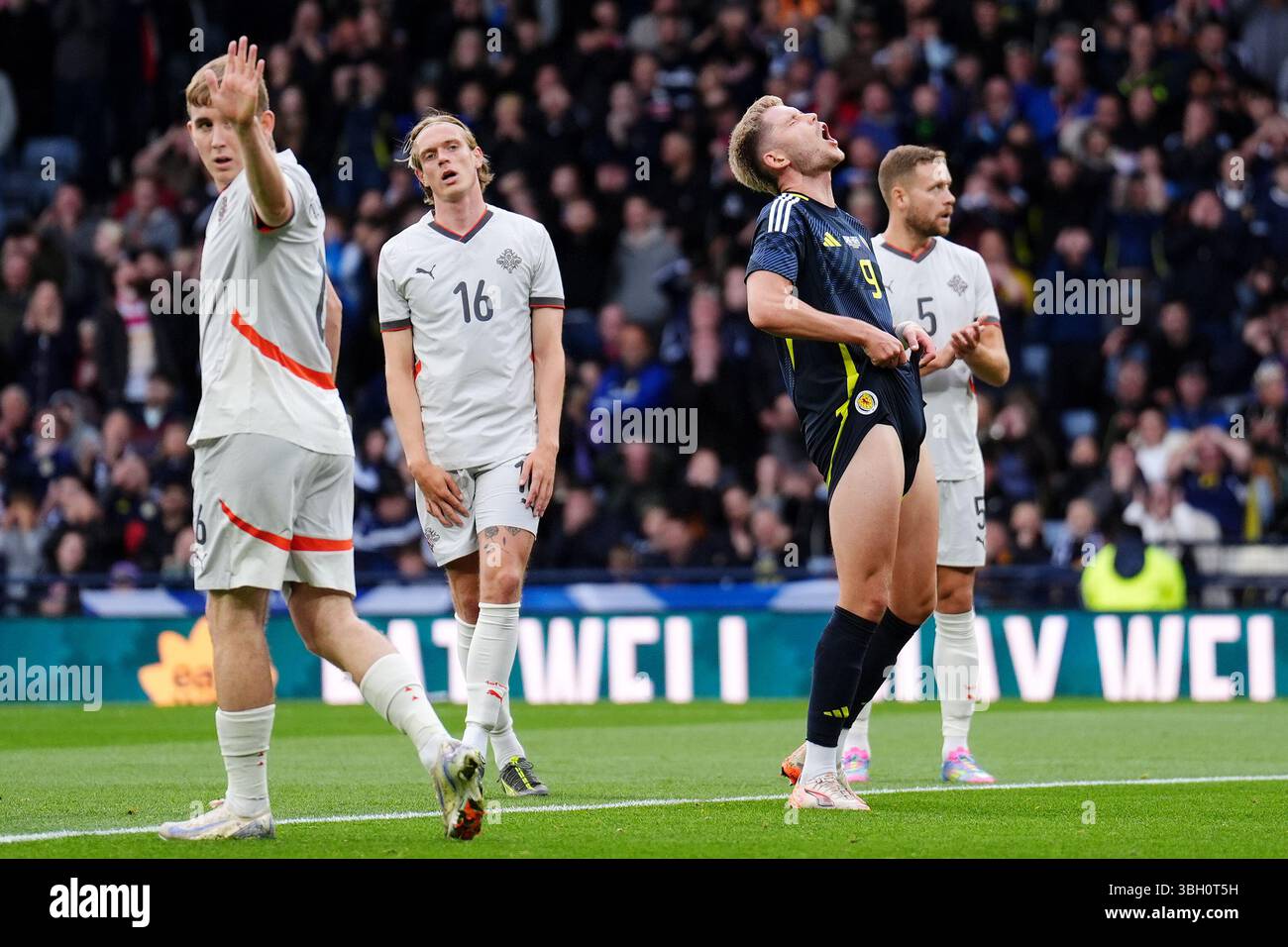 Scotland's George Hirst (right) reacts to a missed opportunity during ...