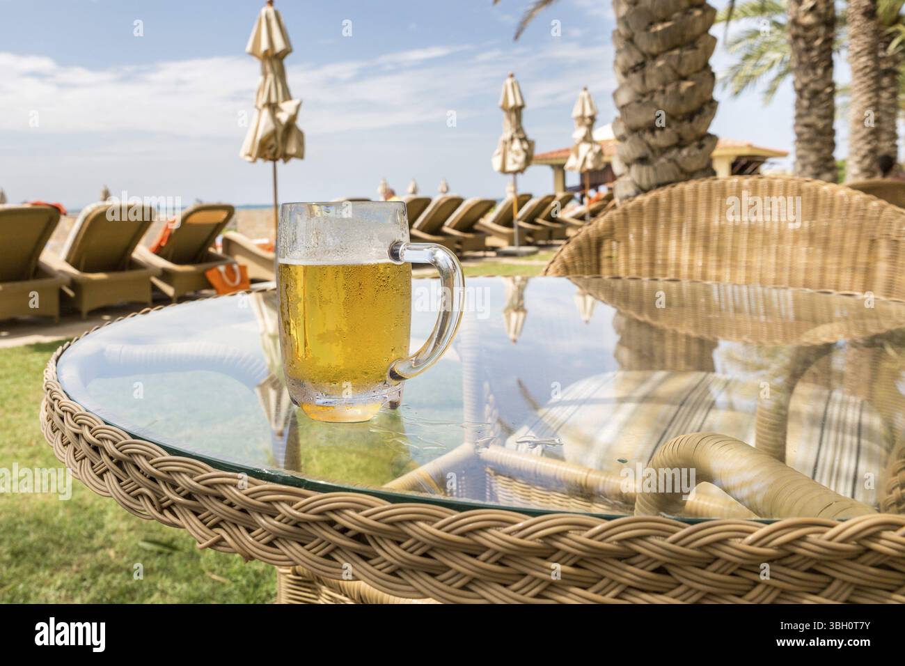 A glass of ice cold beer placed on a table at a vacation spot Stock ...