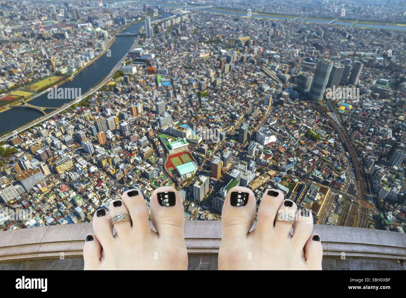 Barefoot woman on top of a building thinking of suicide, over Tokyo ...