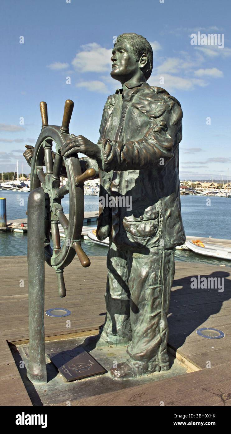 Bronze statue in the harbour of Vilamoura, the man at the helm of a ...