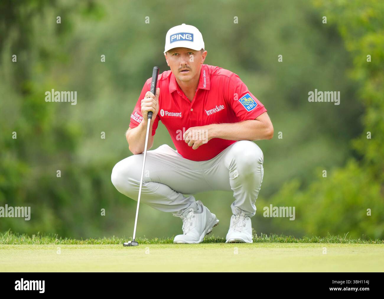 Canadian Mackenzie Hughes eyes up a putt on the first green during the ...
