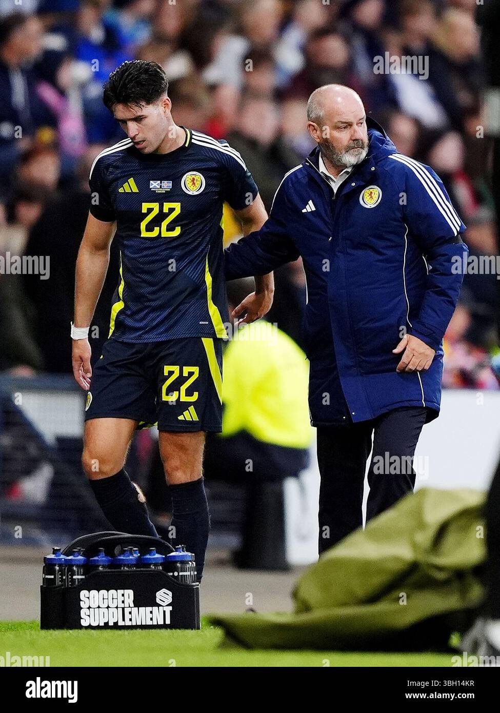 Scotland's Max Johnston is substituted (left) and embraced by manager ...