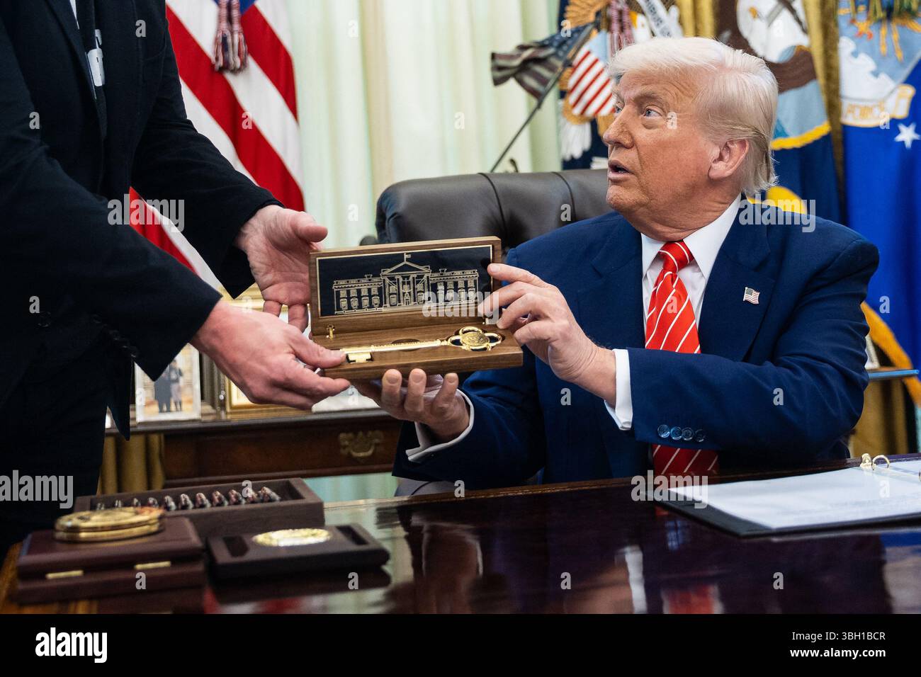 Washington, United States. 30th May, 2025. President Donald Trump hands ...