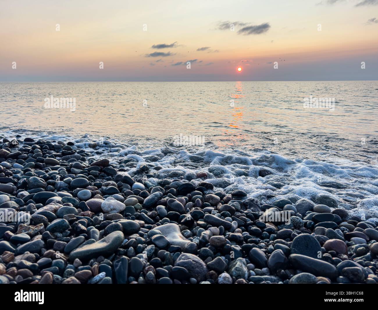 Pebble beach with waves and sunset on Black Sea, Batumi, Georgia ...