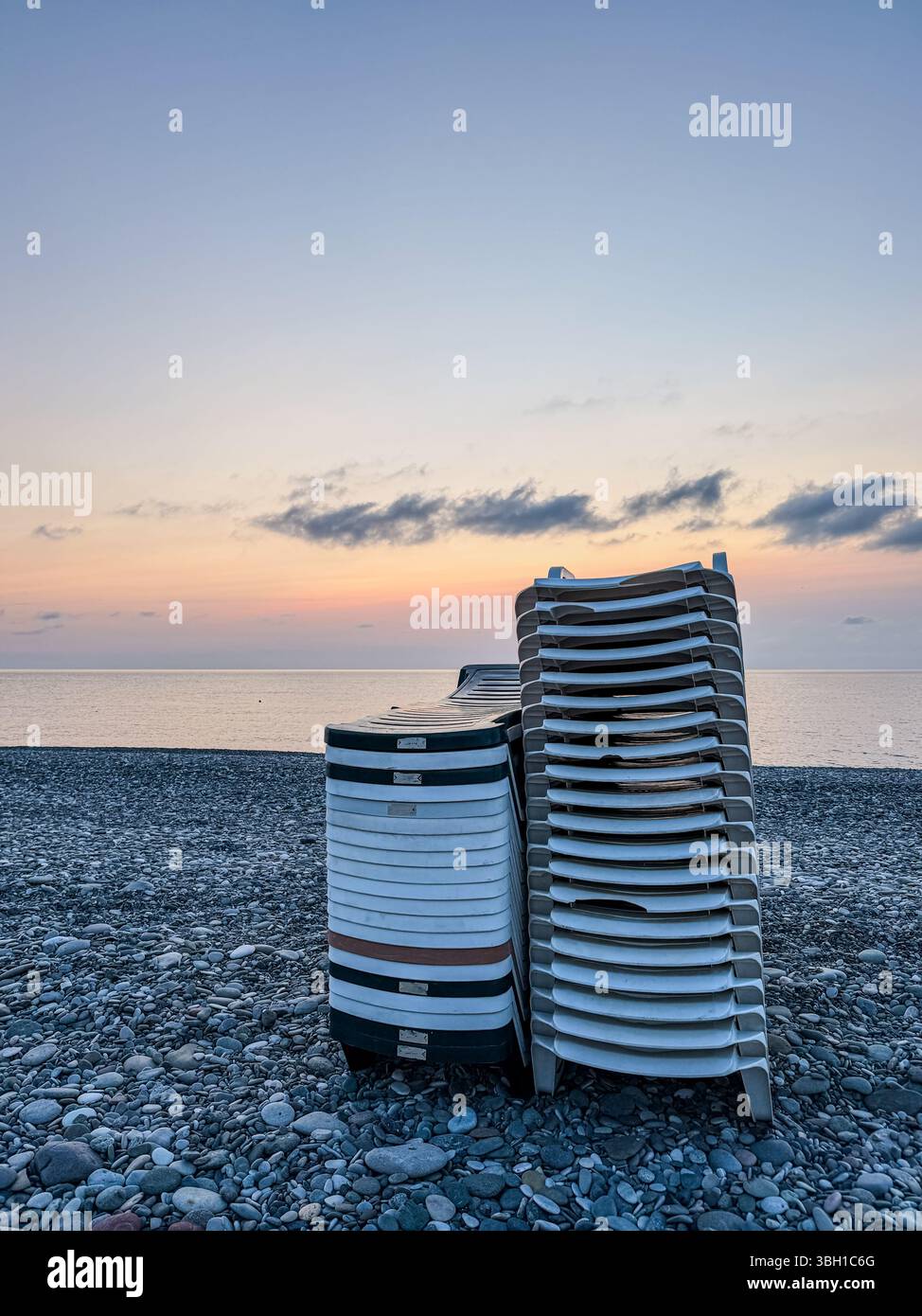 Stack of sun loungers on beach hi-res stock photography and images - Alamy