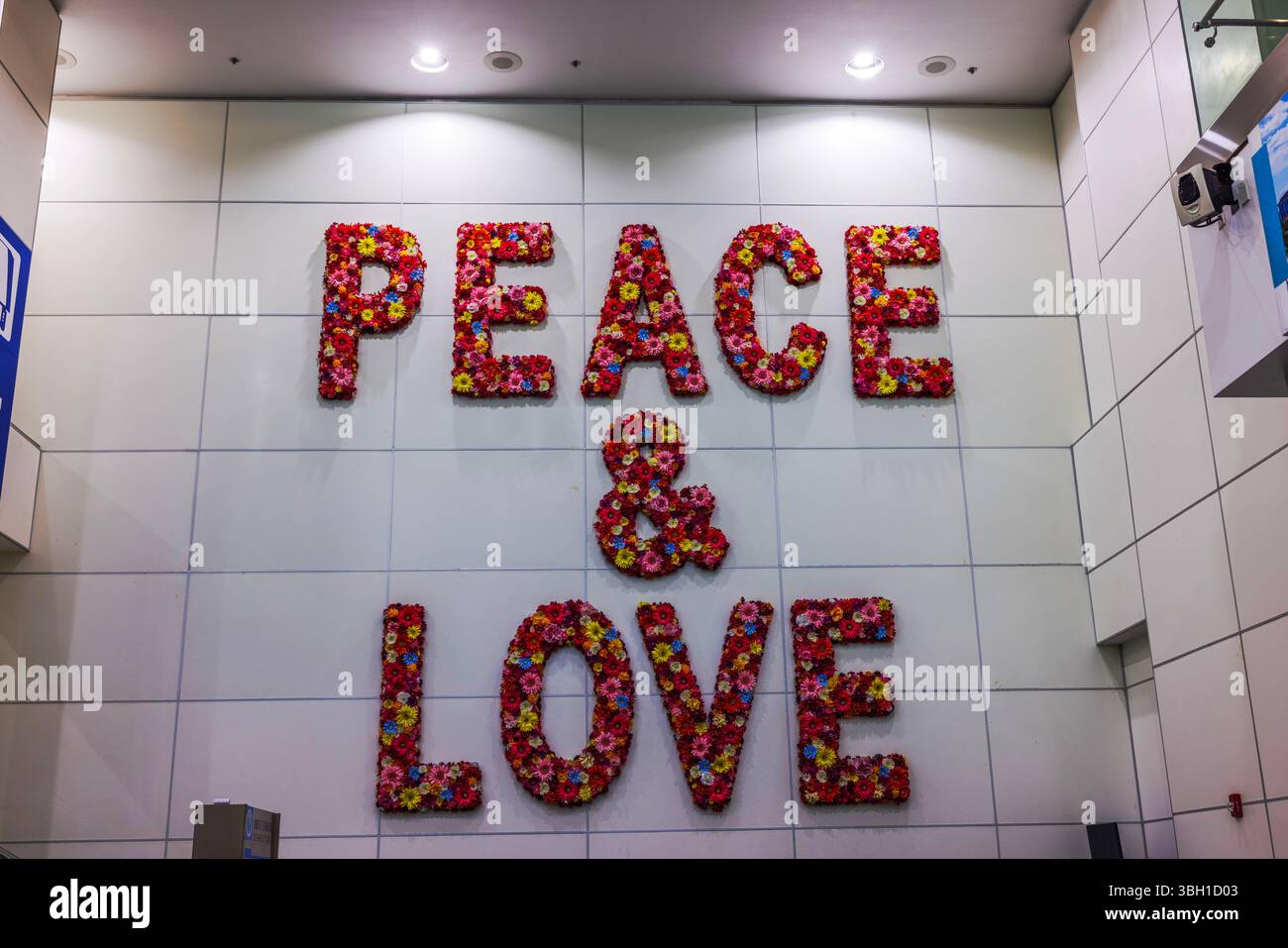 Colorful floral Peace and Love sign on tiled wall inside Miami ...