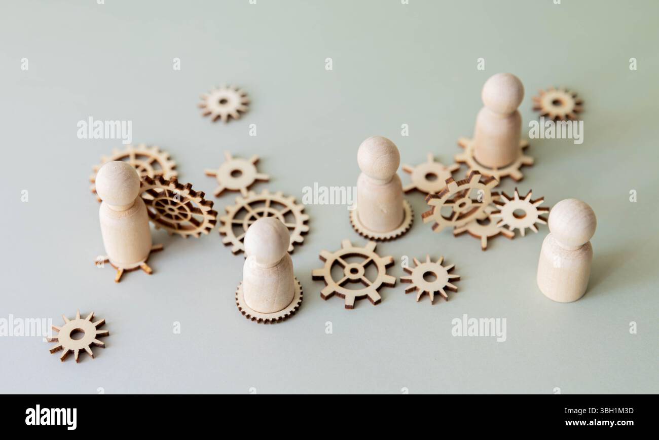 A Conceptual Image With Wooden Figures Standing On Interconnected Gears Teamwork Collaboration