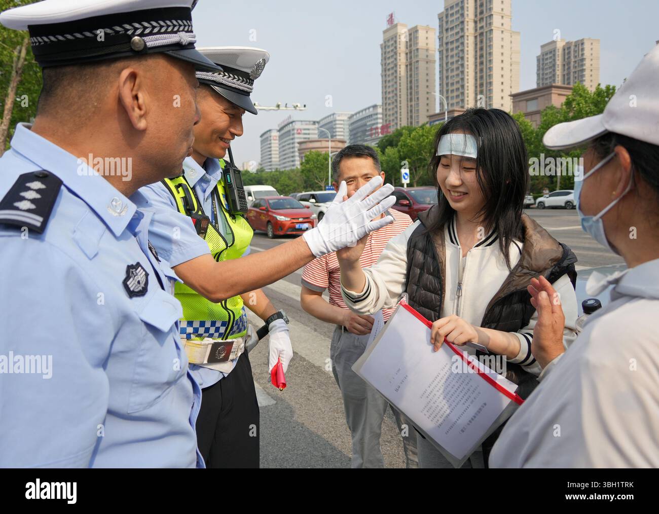 YANTAI, CHINA - JUNE 7, 2025 - A traffic police officer on duty cheered ...
