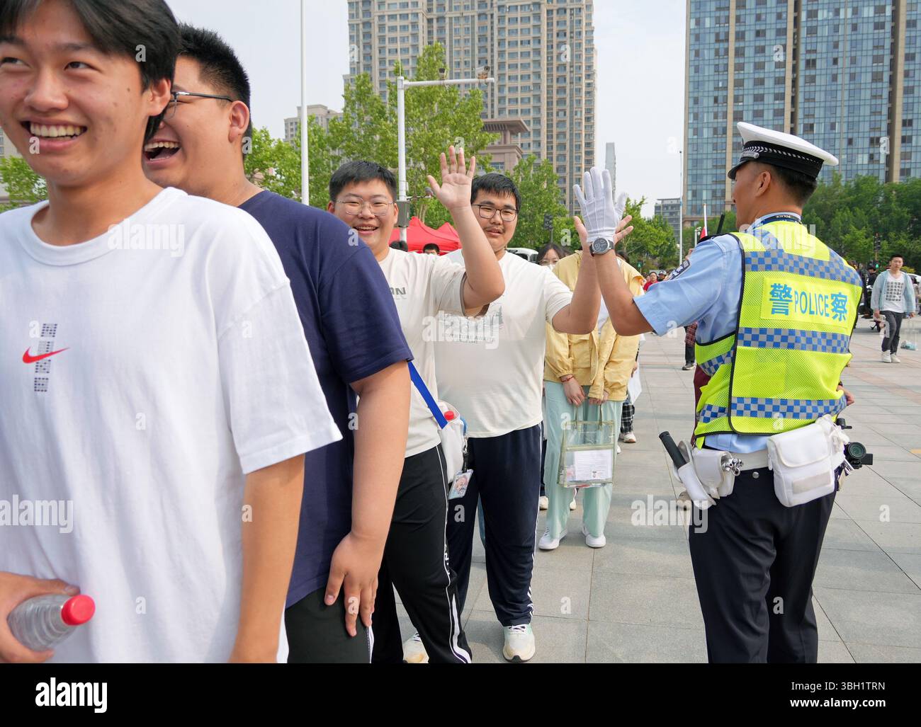 YANTAI, CHINA - JUNE 7, 2025 - A traffic police officer on duty cheered ...
