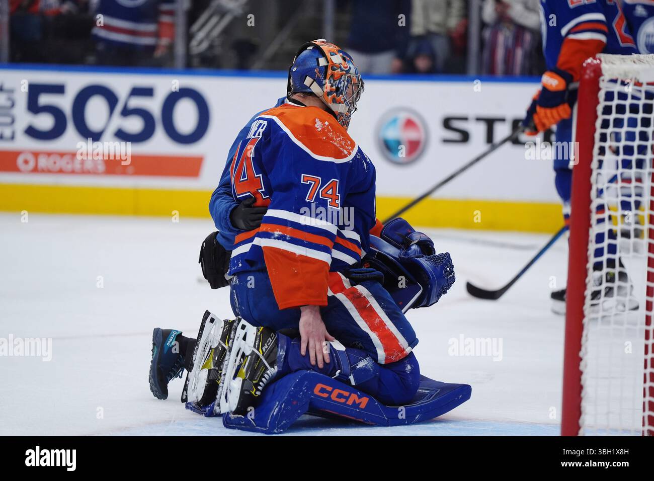 Edmonton Oilers goalie Stuart Skinner (74) is checked on by medical ...