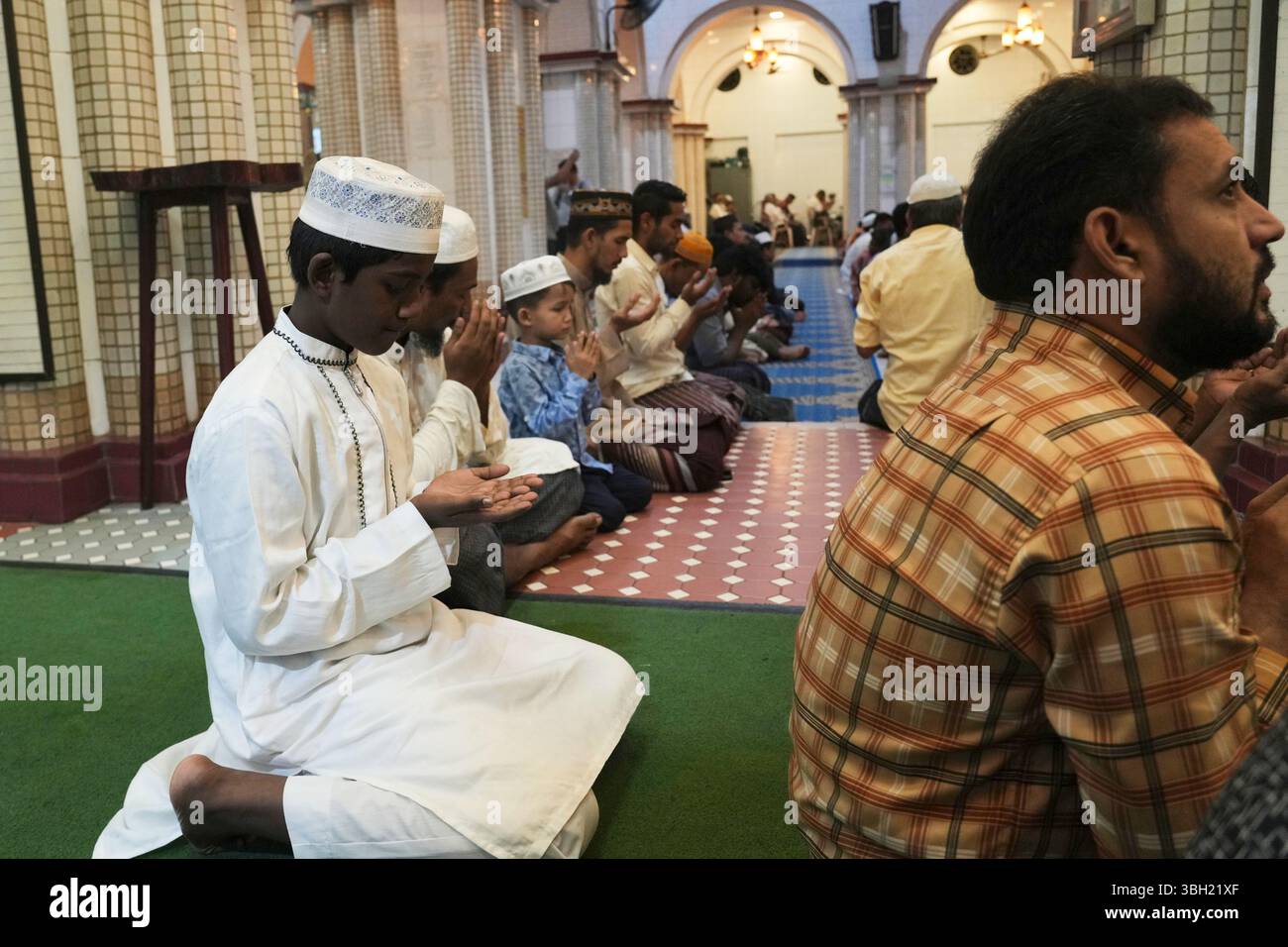 Myanmar Muslims offer a prayer to mark celebrations of Eid al-Adha at a ...