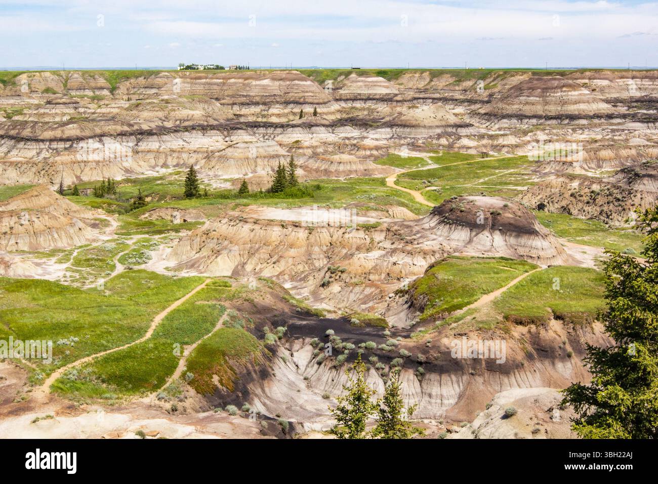 A lookout point of the multicolored badlands and prairie farmland in ...