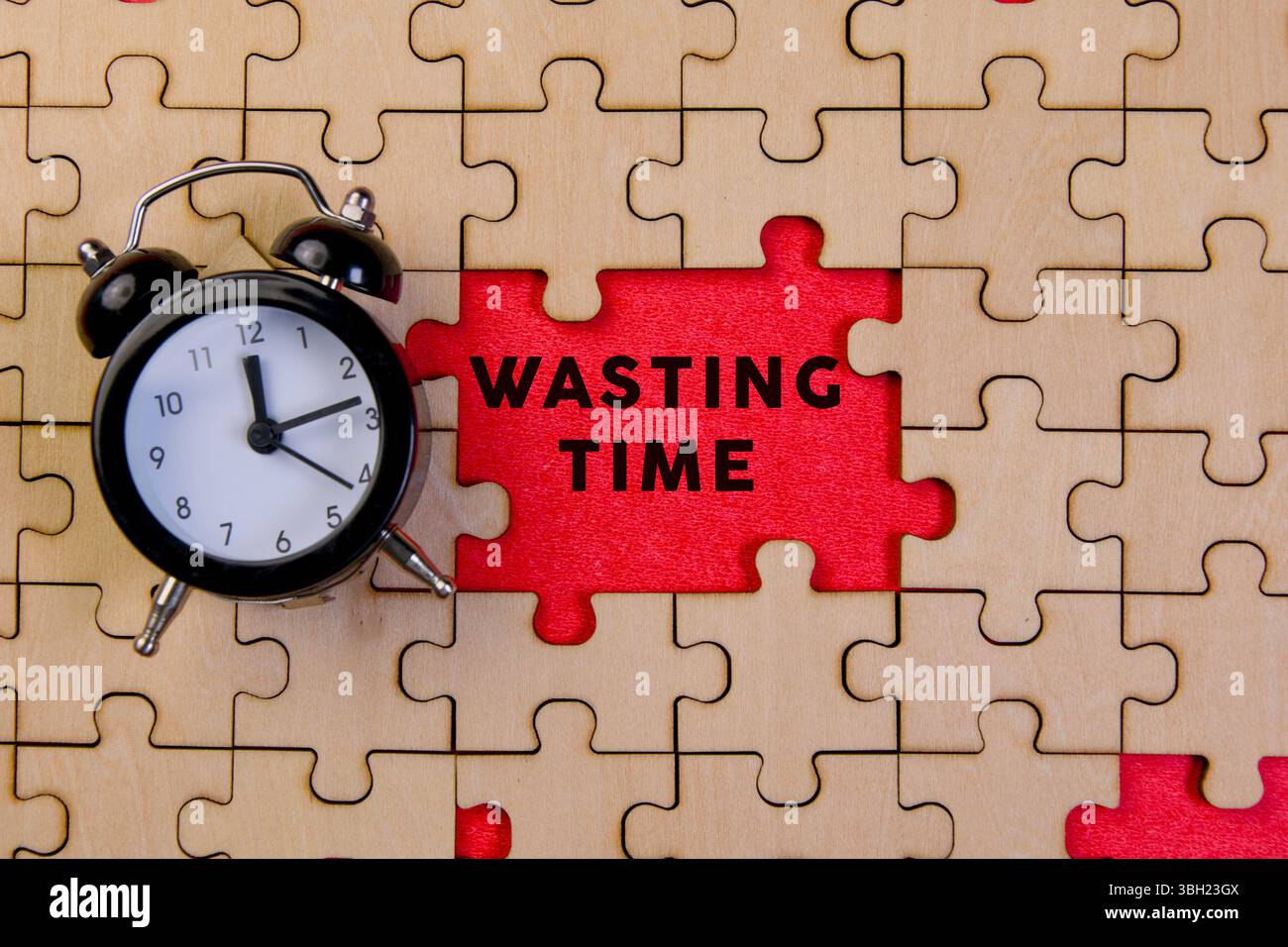 An old-fashioned clock rests on red puzzle pieces, highlighting the ...