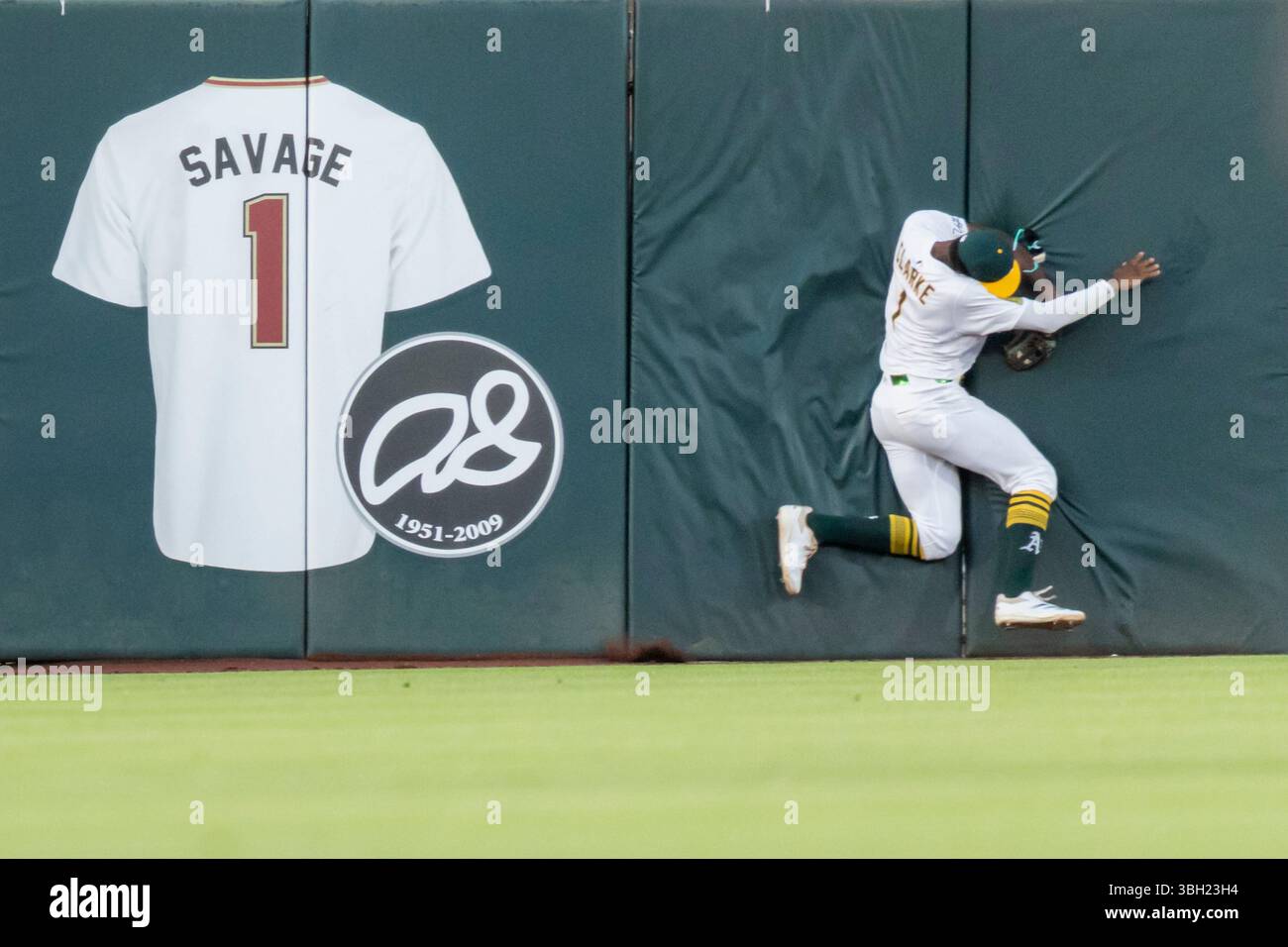 Athletics outfielder Denzel Clarke collides into the wall after making ...