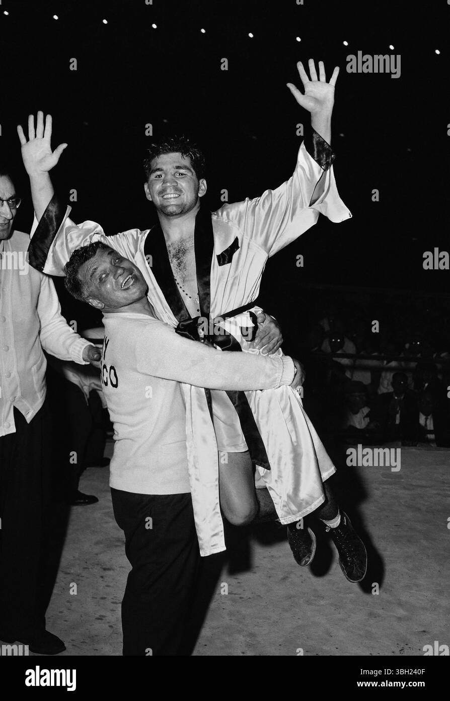 Tony Demarco is lifted by trainer Sammy Fuller following his unanimous ...