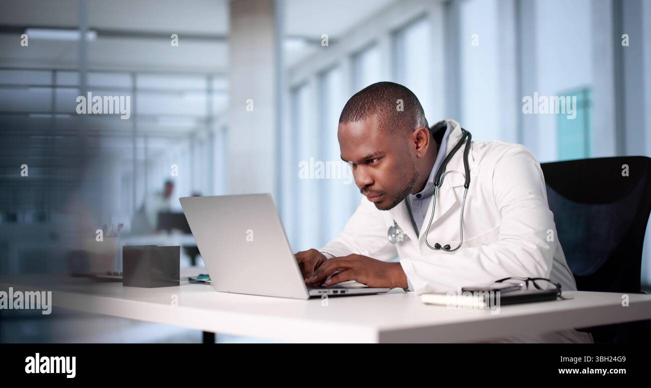 African American Doctor With Poor Posture Sitting At Computer Desk ...