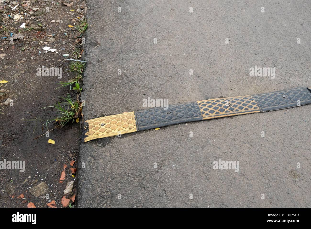 black and yellow speed bumps in the middle of the road Stock Photo - Alamy
