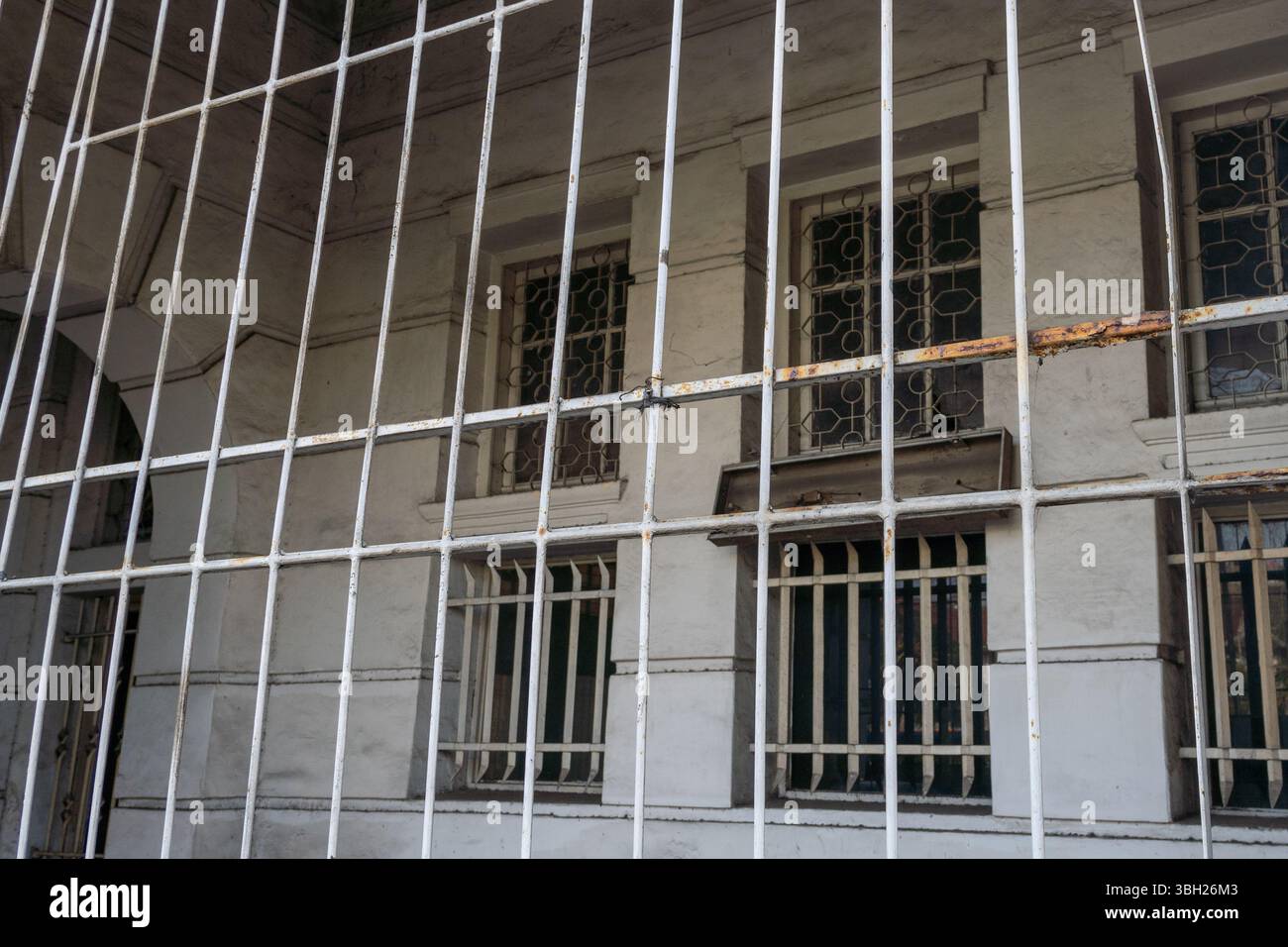 White old building with a iron trellis door and an old style windows ...