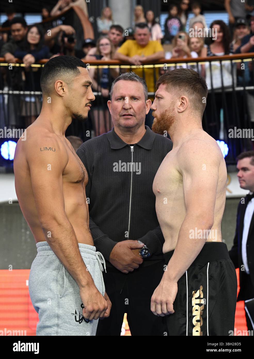 Australian boxer Jai Opetaia (left) faces off with Claudio Squeo of ...