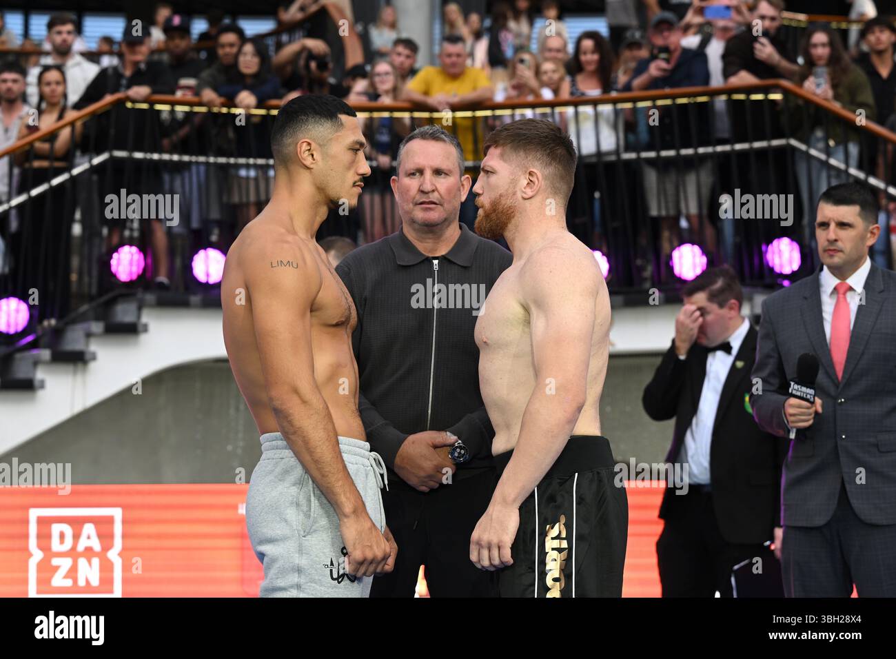 Australian boxer Jai Opetaia (left) faces off with Claudio Squeo of ...