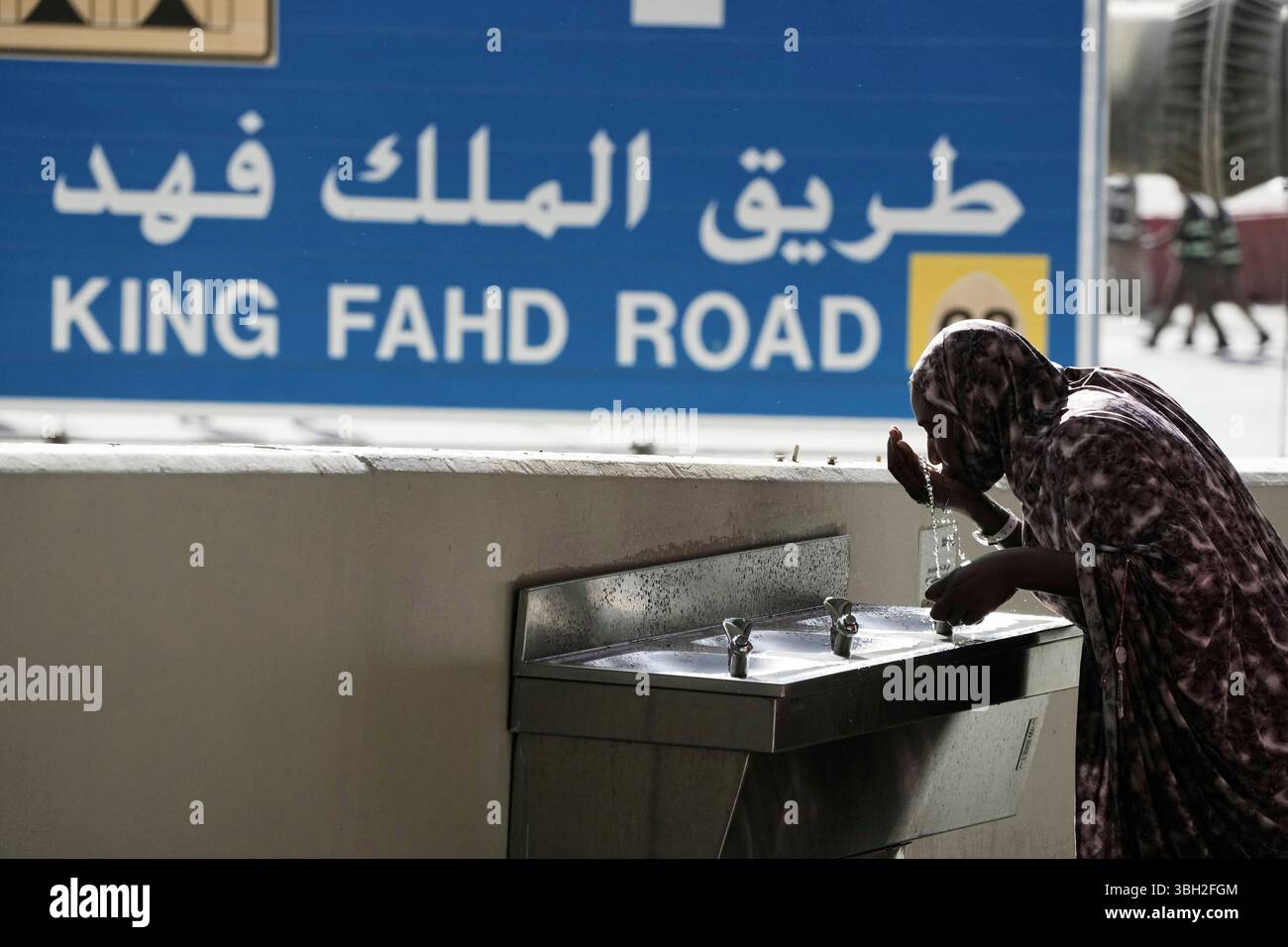 A Muslim pilgrim drinks water after she casts stones at pillars in the symbolic stoning of the ...