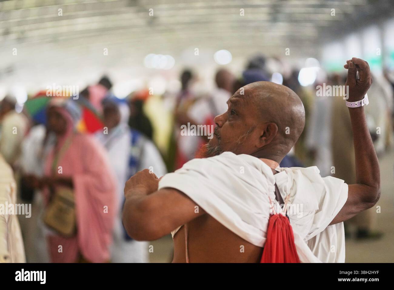 A Muslim pilgrim casts stones at pillars in the symbolic stoning of the ...