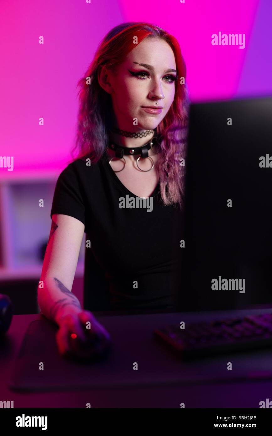 Focused gamer with colorful hair in vibrant gaming setup Stock Photo ...