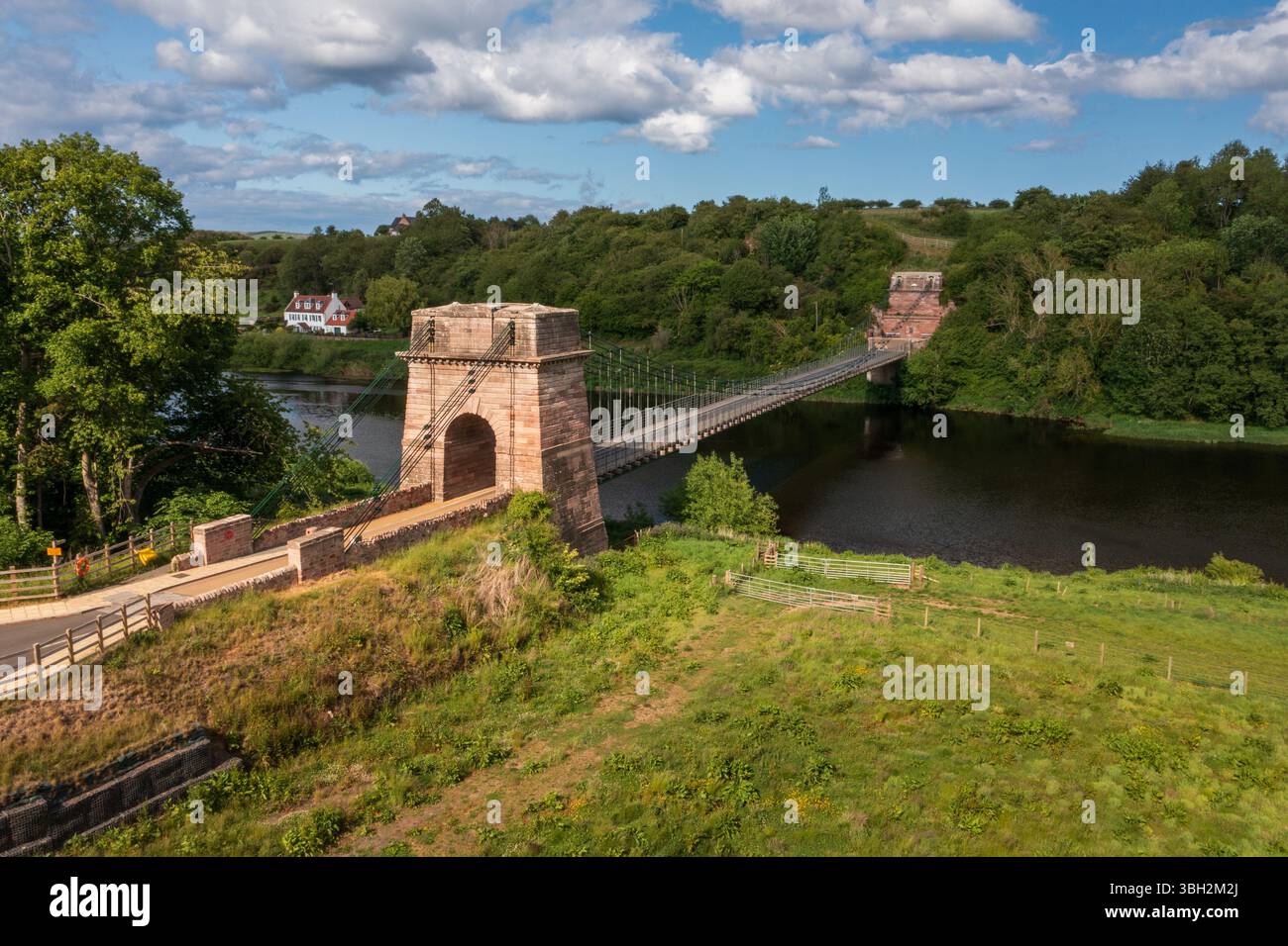 Summer and the newly restored Union Chain Bridge spans the River Tweed ...