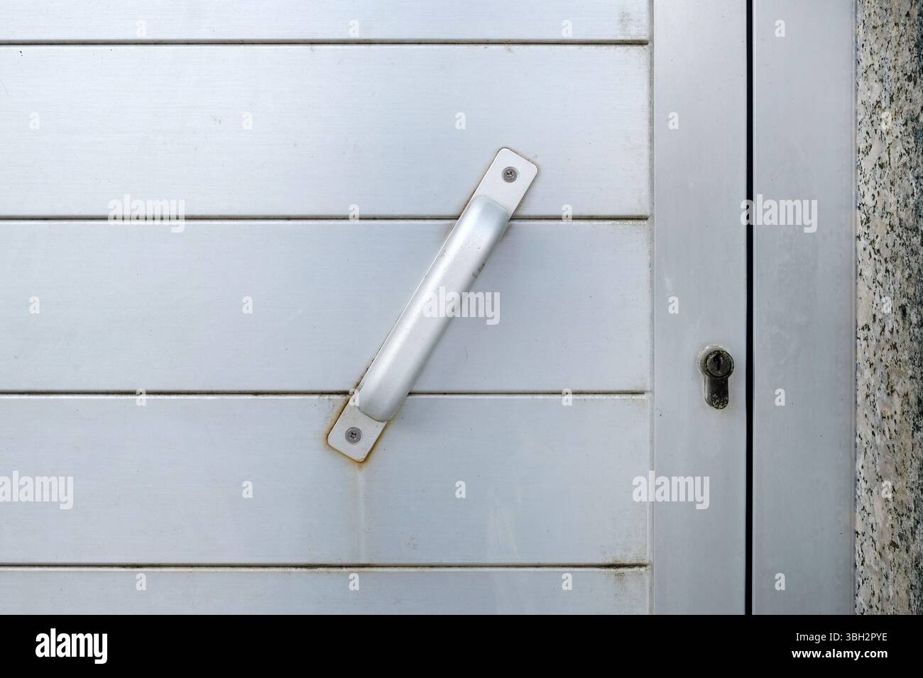 Locked metal door with a metal handle Stock Photo - Alamy