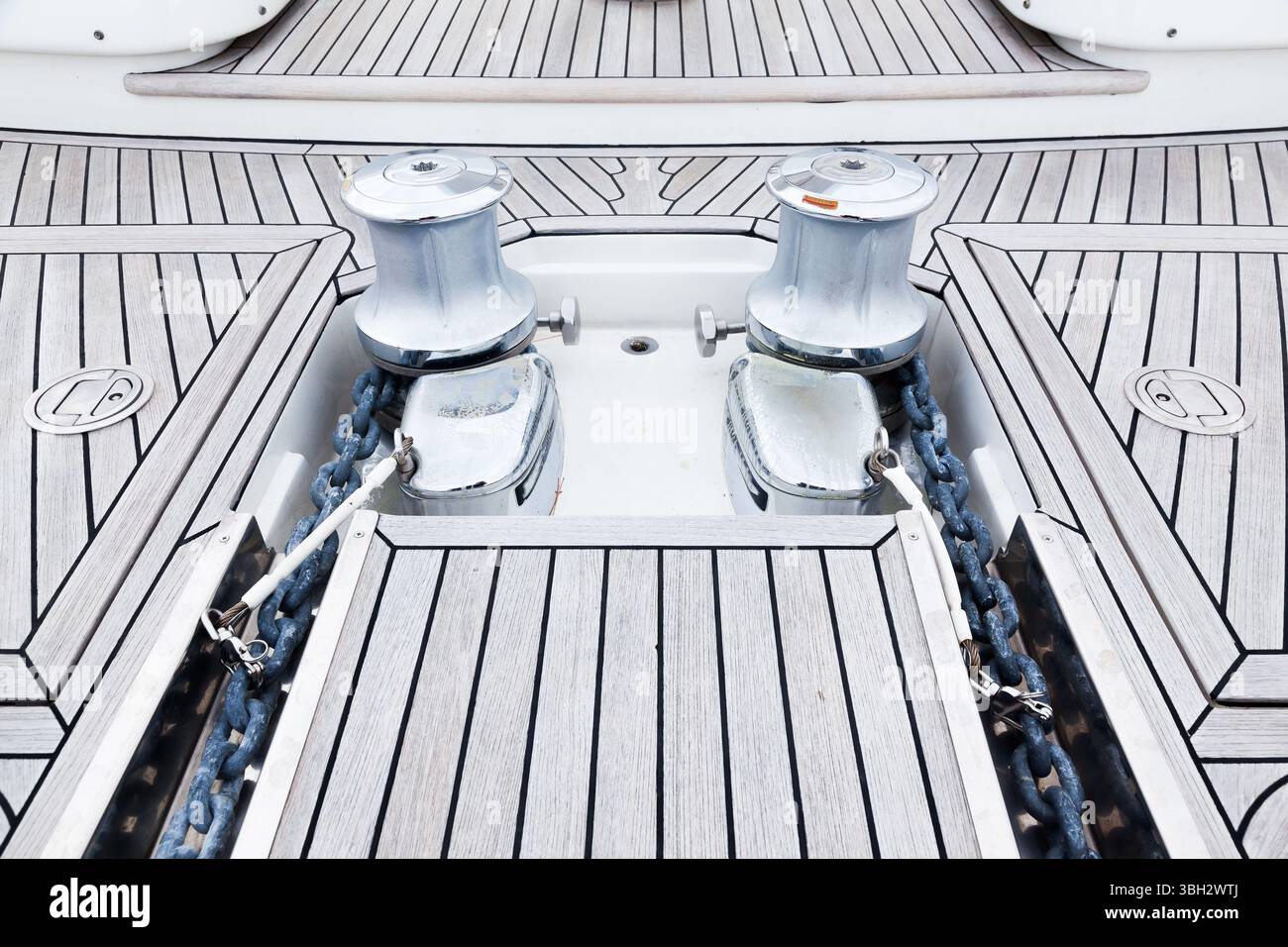 The bow is a teak deck of a luxury yacht, with stainless steel winches, anchor chain attachments ...
