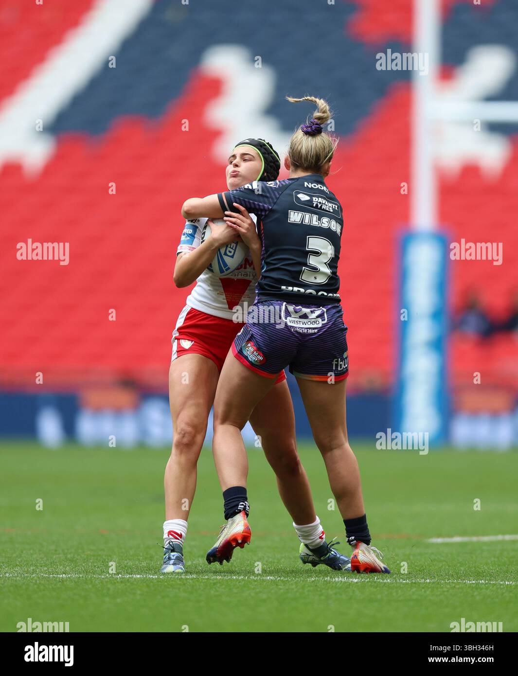St Helens' Beri Salihi is tackled by Wigan Warriors' Georgia Wilson ...