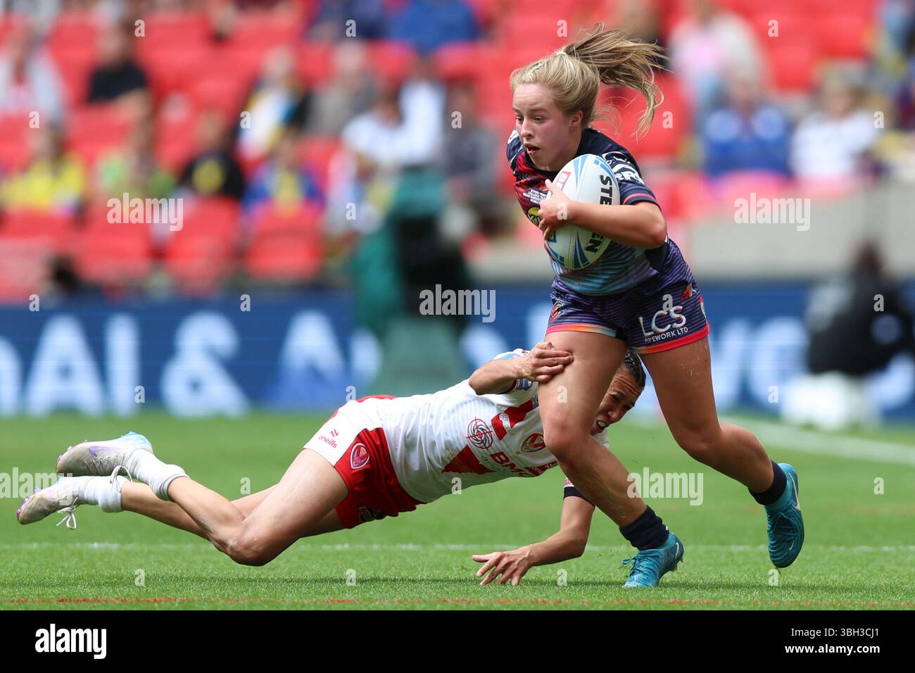 Wigan Warriors' Ellise Derbyshire (right) is tackled by St Helen’s Zoe ...