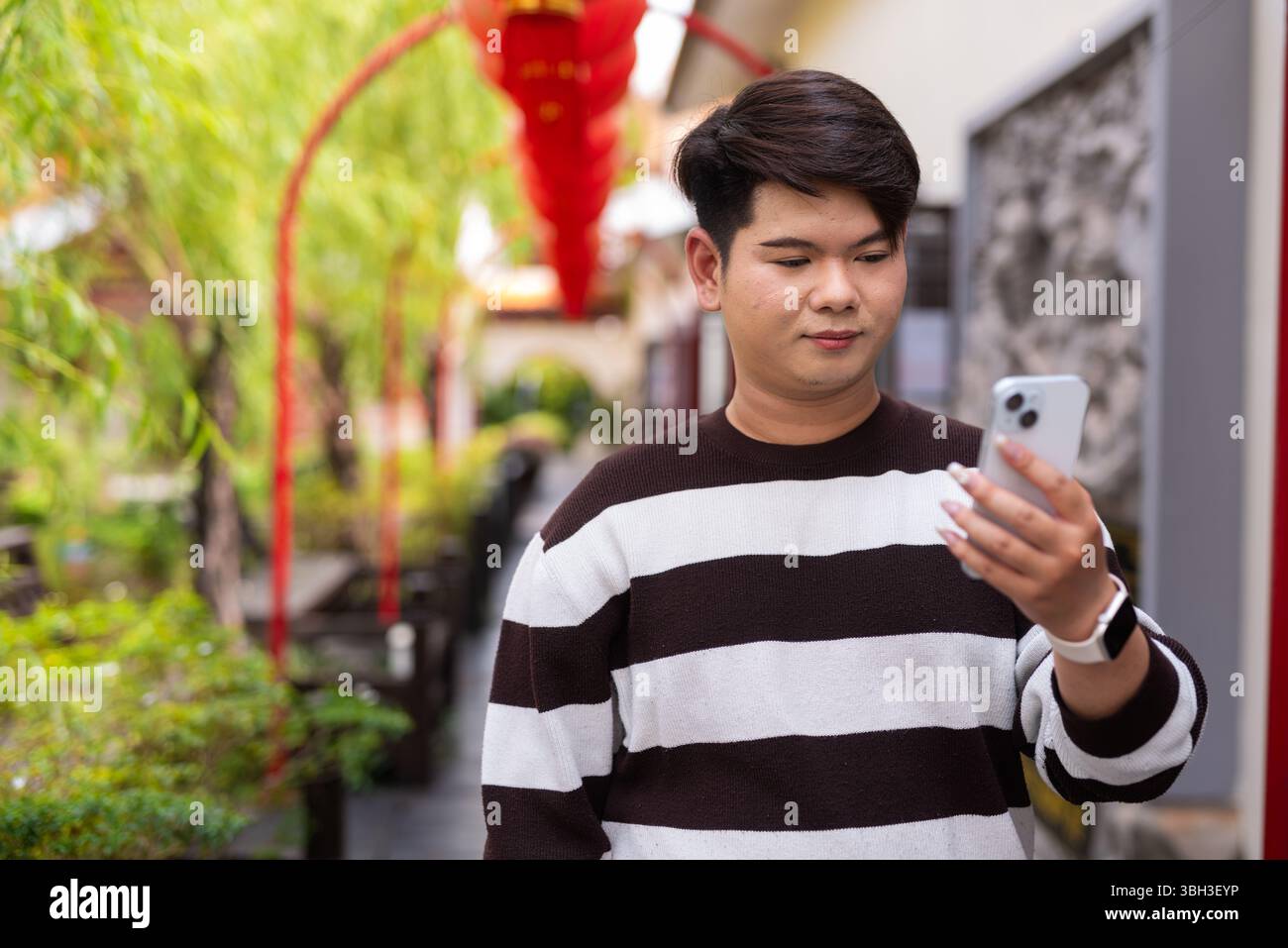 Young cute Asian gay man in Chinese style Zen garden during day Stock ...