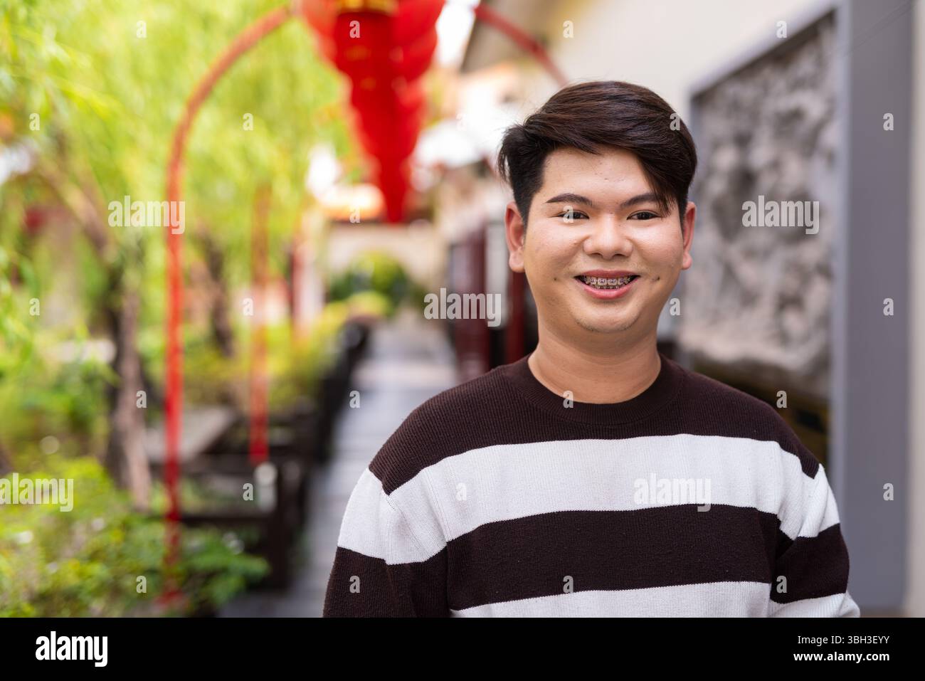 Young cute Asian gay man in Chinese style Zen garden during day Stock ...