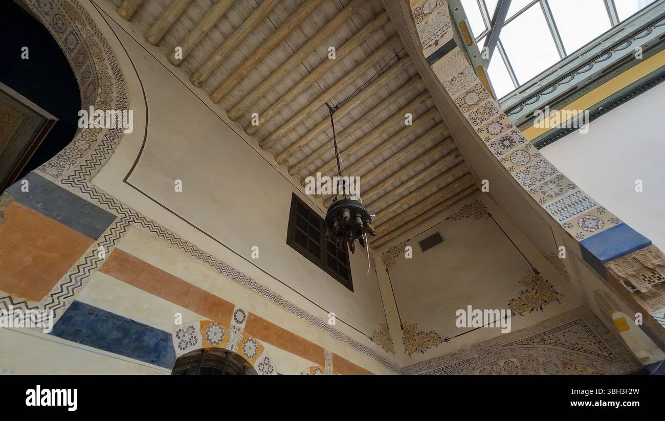 Traditional Middle Eastern architecture with ornate designs and a chandelier. In Damascus old ...