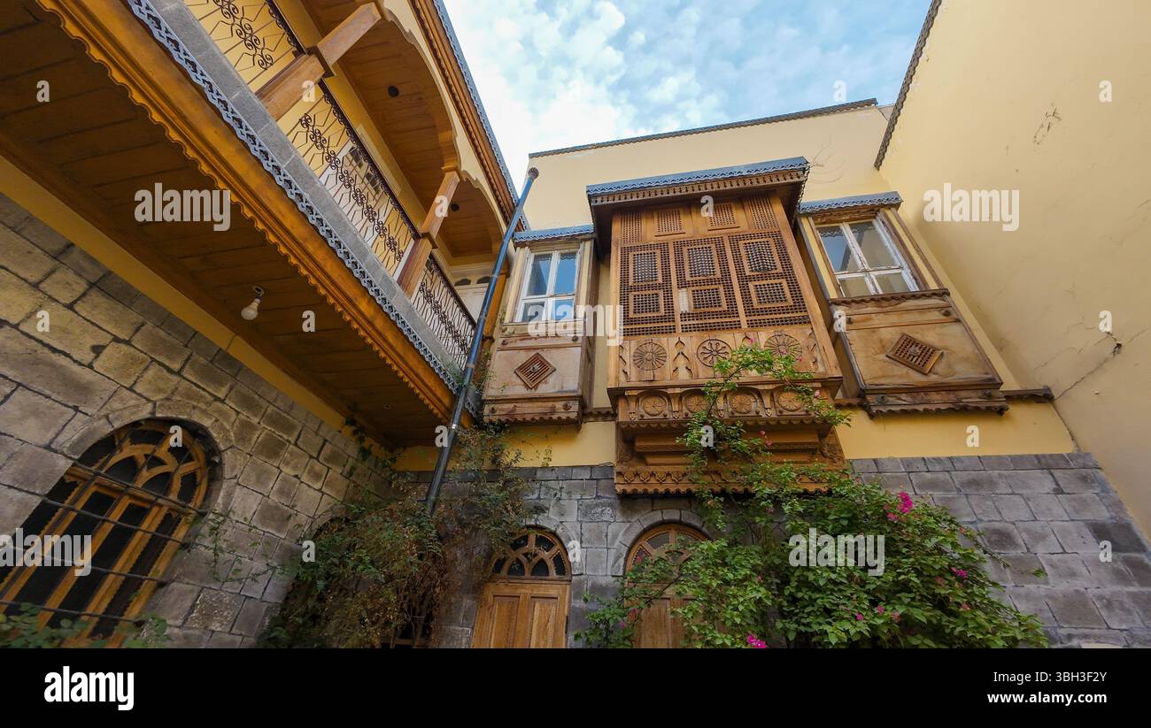 Traditional Middle Eastern architecture with wooden balconies and stone ...