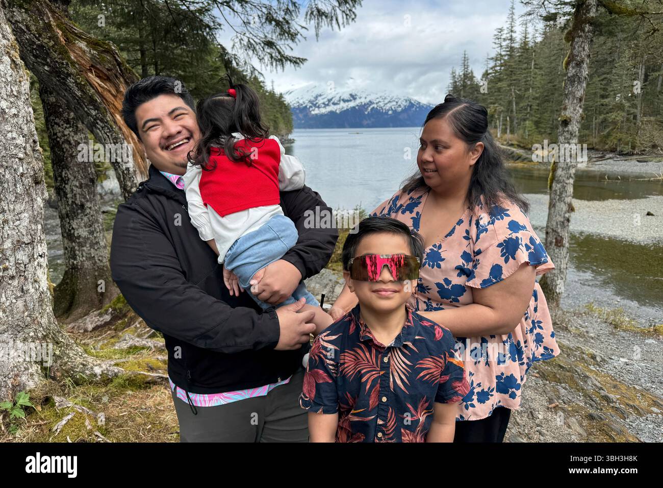 Michael Pese and his wife, Tupe Smith, pose for a photo with their son ...