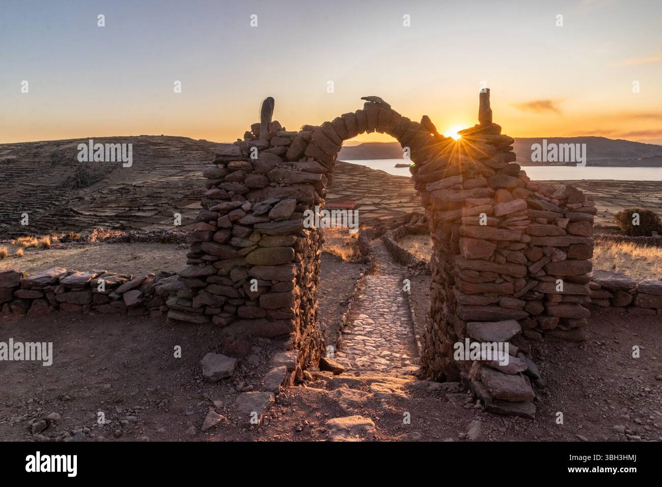 Sunset view of a stone gateway on Pachatata hill on Amantani island in ...