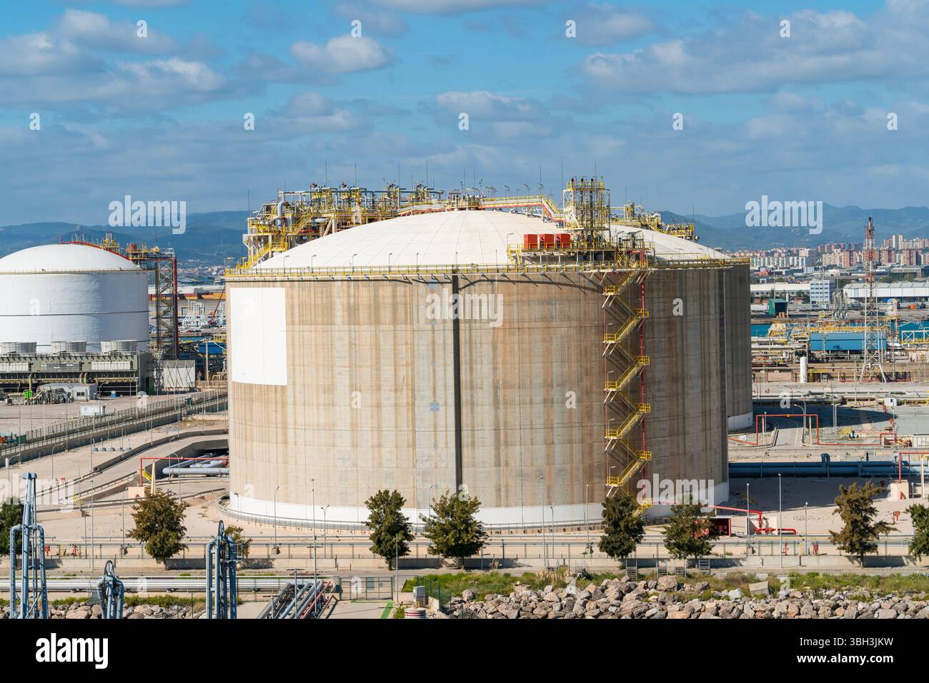 Massive round industrial storage tanks at a petrochemical plant ...