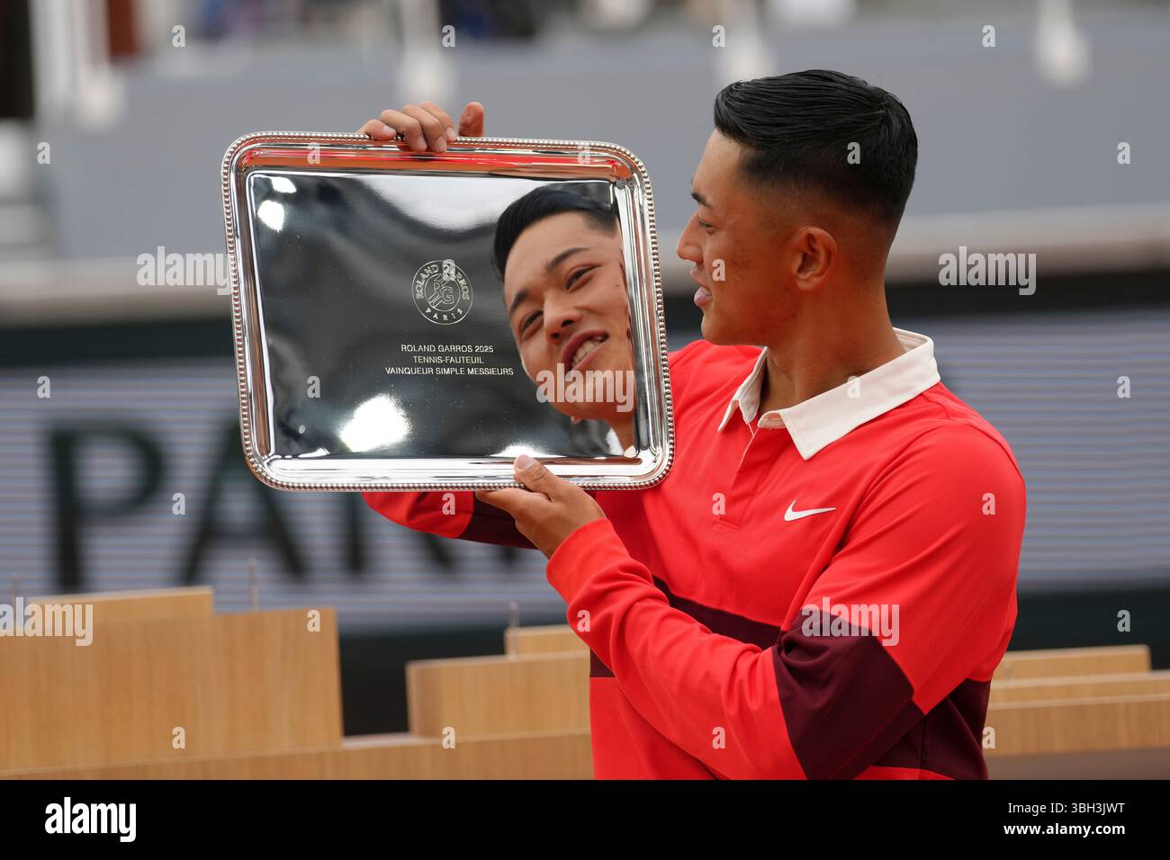 Japan's Tokito Oda poses with the trophy as he won the men's wheelchair ...