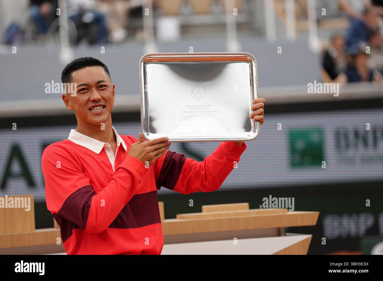 Japan's Tokito Oda poses with the trophy as he won the men's wheelchair ...