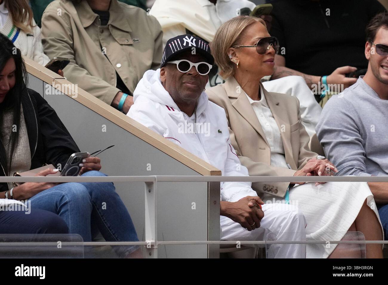 Spike Lee, centre, watches the final match of the French Tennis Open ...