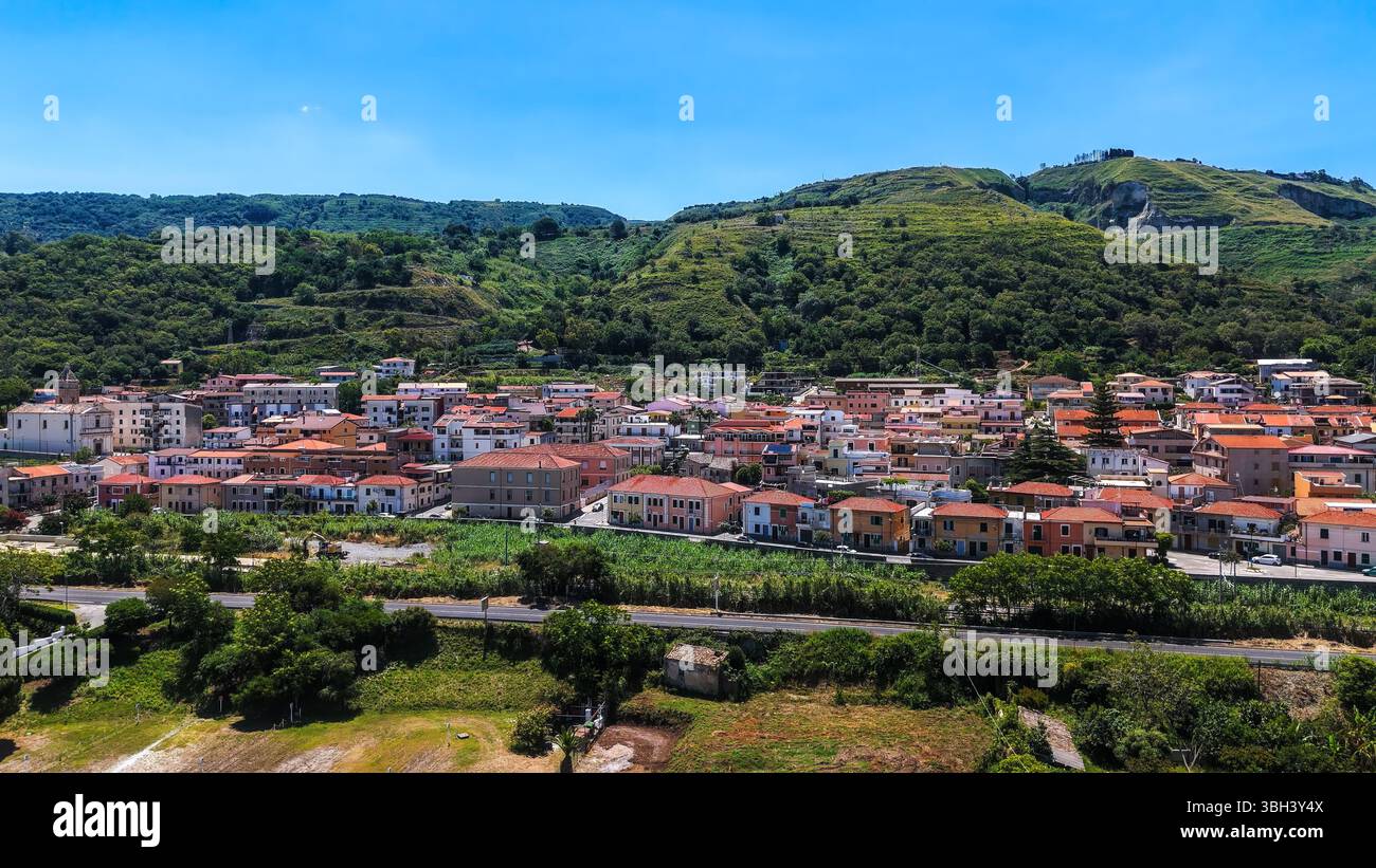 Aerial view of Tropea, a charming town nestled between lush green hills ...