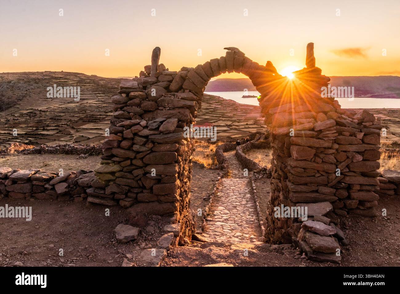 Sunset view of a stone gateway on Pachatata hill on Amantani island in ...