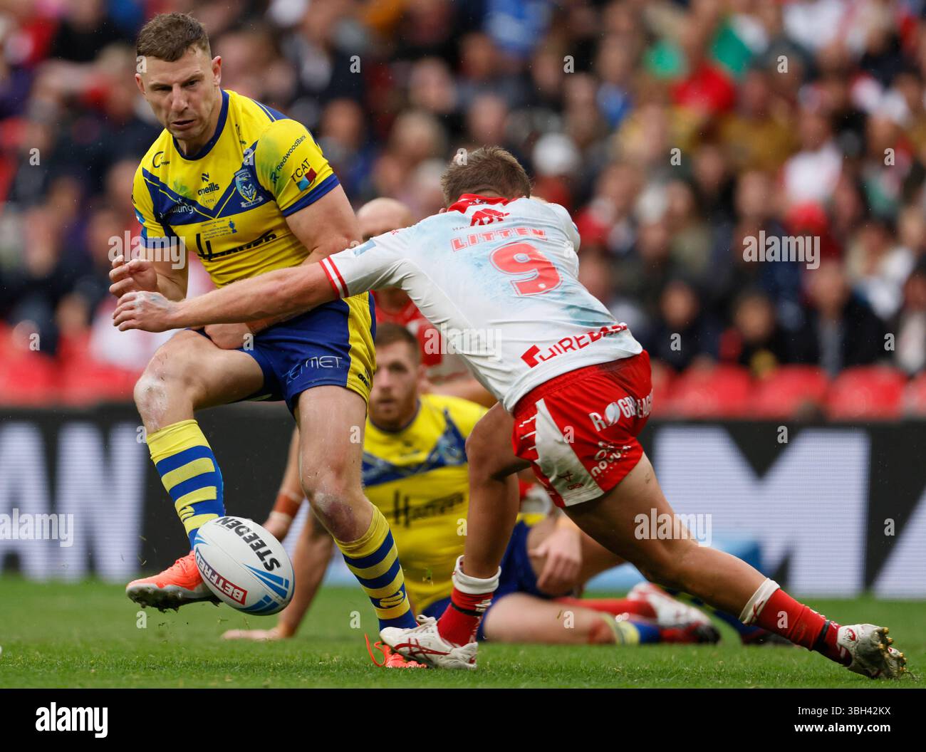 Warrington Wolves' George Williams (left) kicks a through pass during ...