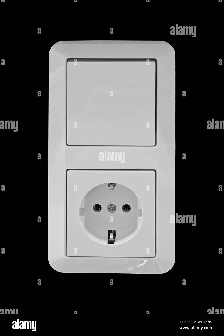 A sleek electrical socket paired with a switch on a black background ...