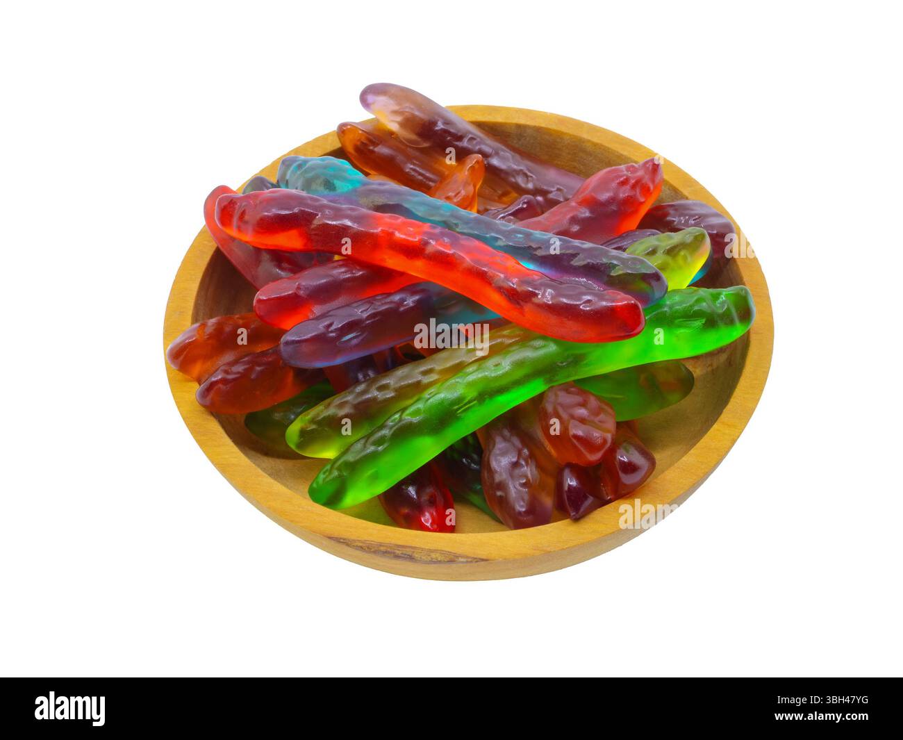 Side view of a small bowl filled with gummi candy snakes on a white ...