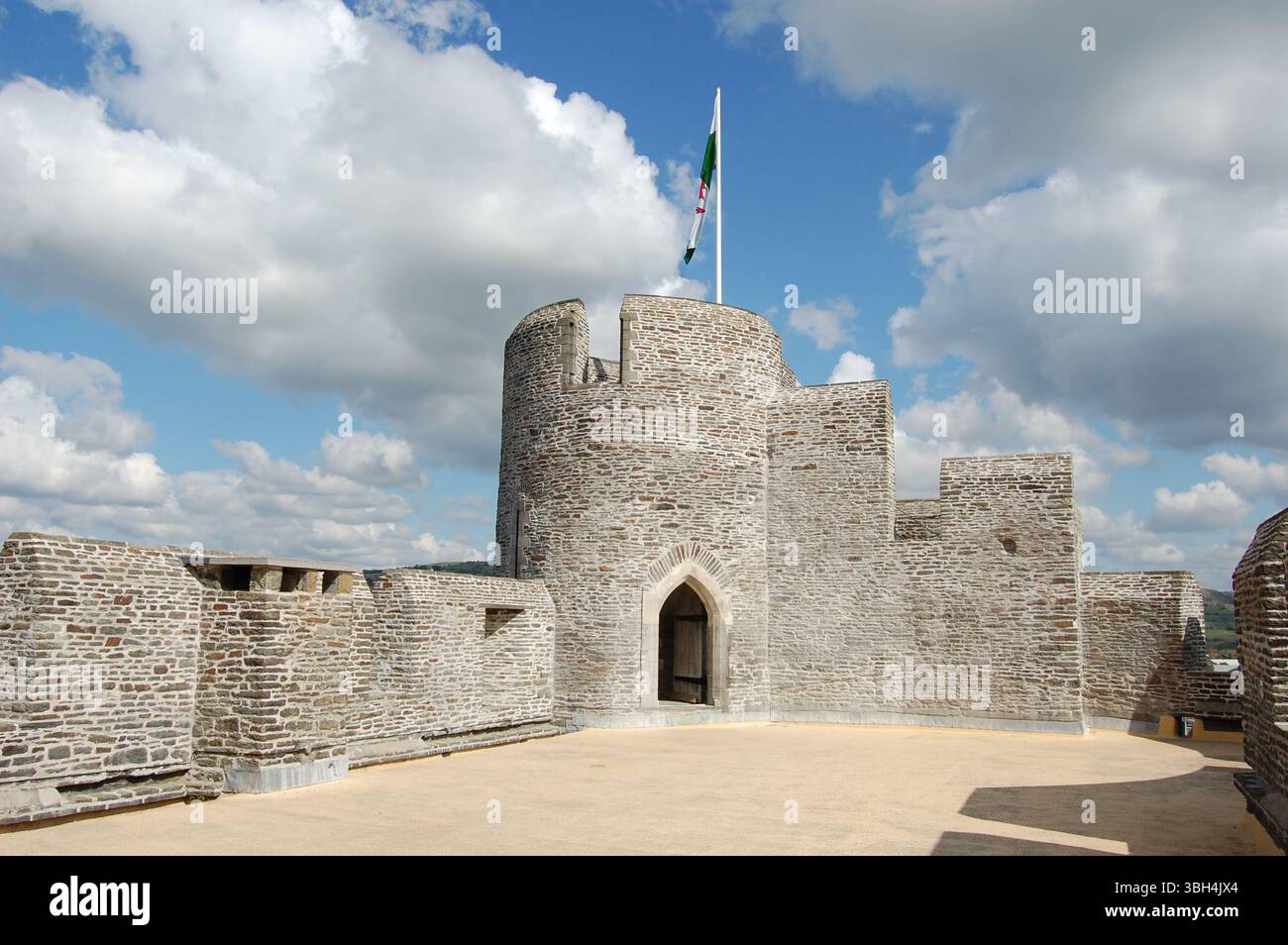 Caerphilly Castle, with tower, battlements and the Welsh flag flying ...