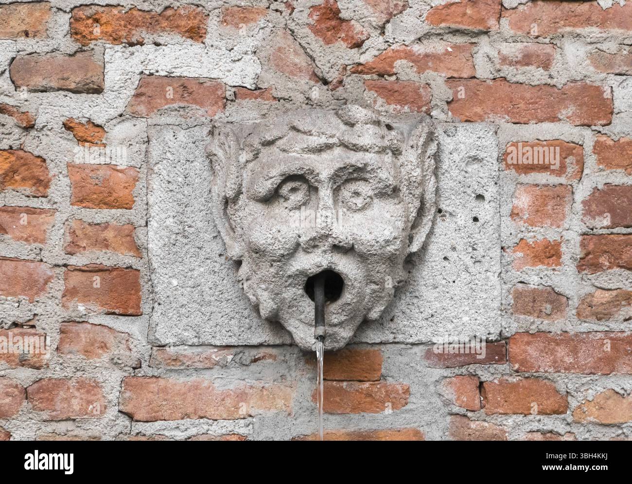 Fountain with a human face Stock Photo - Alamy